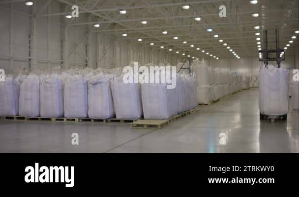Bags handling to stacking in warehouse by forklift. Forklift with a big ...