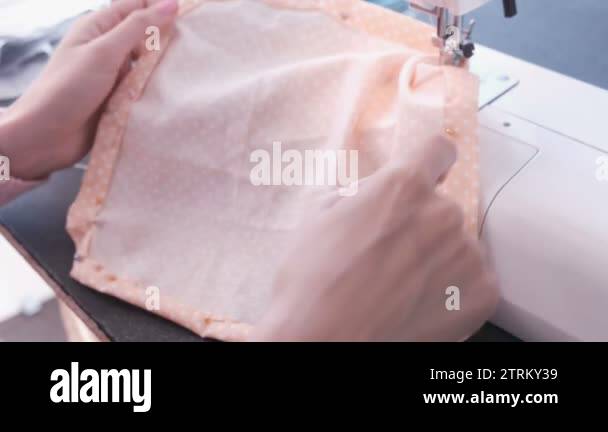 Woman sewing detail on the sewing machine. Shows and explains how to ...