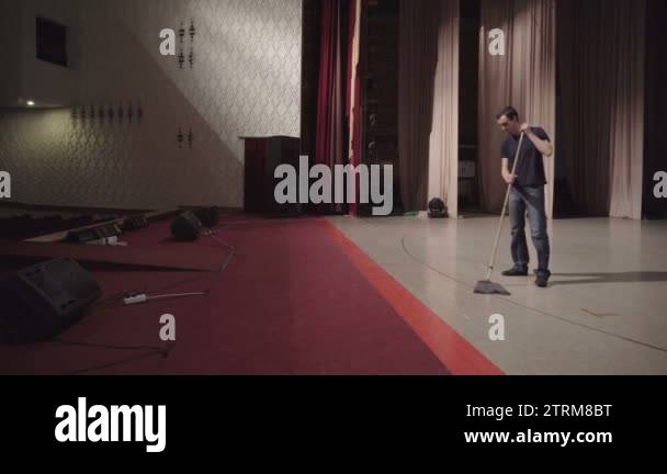 Man washes theater stage using a mop Stock Video Footage - Alamy