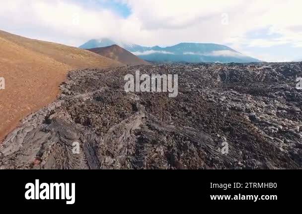 Flying over the lava of the volcano. Tourists in a place where there ...