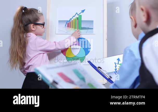 Young children are considered charts in the hands of the boys with the ...