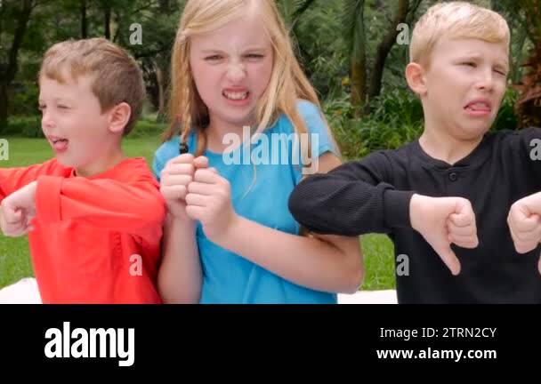 Three young children say yuck and hold their noses in disgust Stock ...