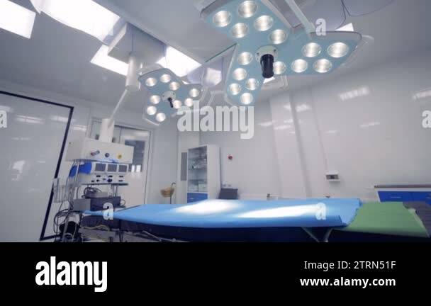 Two surgical lamps hanging above the bed in an operating room. Bright ...