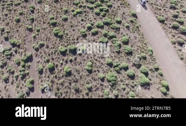 Aerial drone scene of steppe landscape and gravel route with car ...