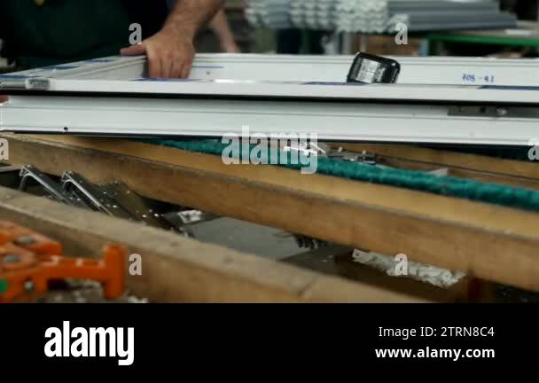 Production and manufacturing of pvc windows, male worker produces pvc ...