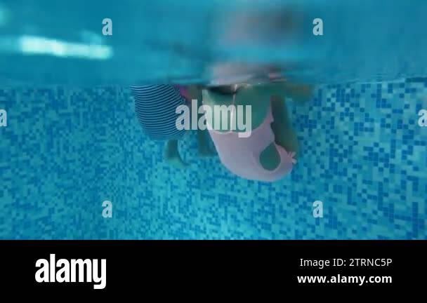 4k video of two girls in swimsuit having fun in swimming pool and doing ...