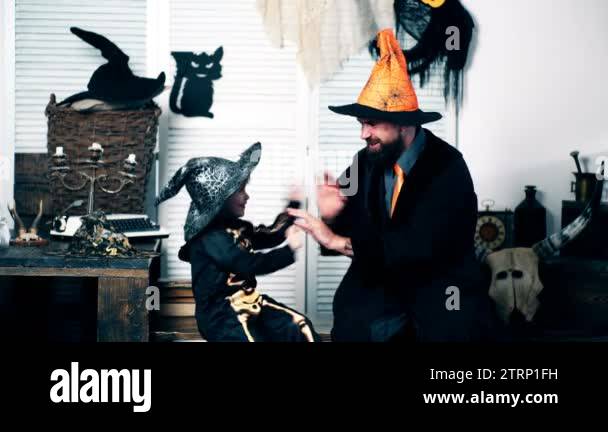 The father in the suit of a sorcerer and his son in a skeleton suit ...