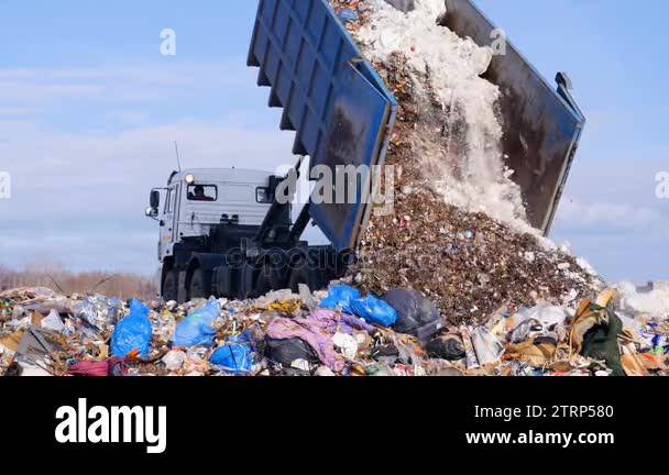 4K. Truck offloading waste into a huge landfill Stock Video Footage - Alamy
