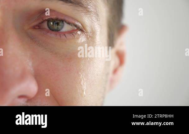 Half face portrait of sad man crying with tears in eye. Man in despair ...