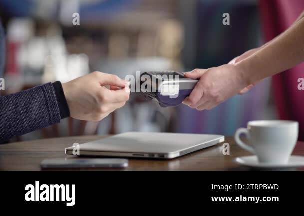 Close up of male and female hands doing process of cashless payment in ...