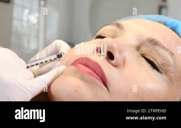 Botox. collagen injections. Doctor makes multiple injections. Face lifting procedure. Senior ...