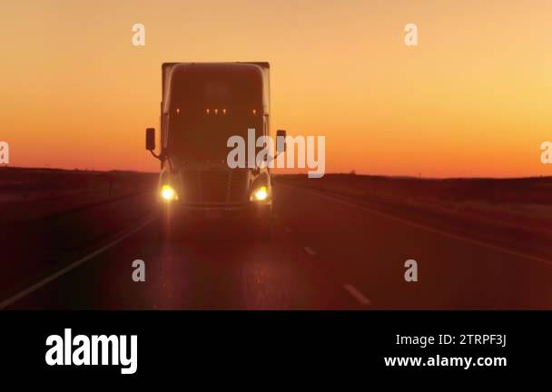 CLOSE UP LENS FLARE: Semi truck driving and hauling goods on empty ...