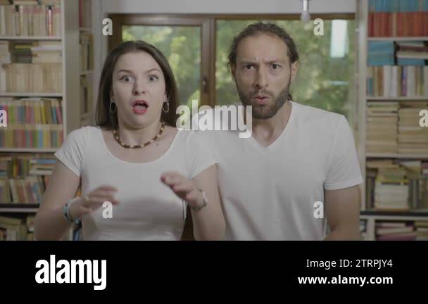 Emotional facial expression of young teenage couple showing shock ...