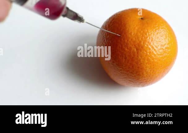 GMO injection with syringe in Orange Stock Video Footage - Alamy