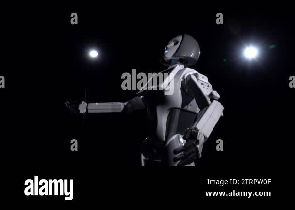 Robot makes movements gesturing with his hands. Black background Stock ...