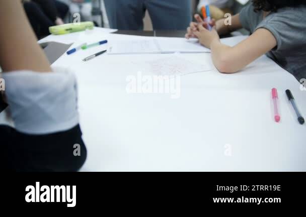 Teenagers draw with markers on a large sheet of paper Stock Video ...
