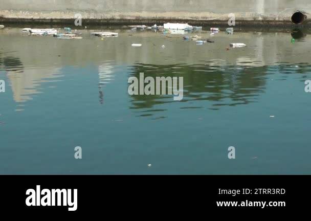 Trash and garbage floating on the surface of the water. Water pollution ...