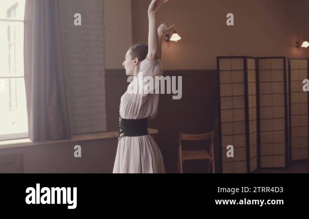 Ballet dance. Ballerina in a simple elegant elegant dress and ...