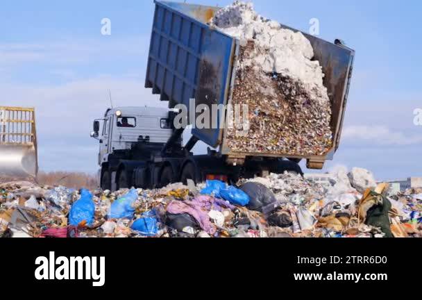 Garbage truck disposed trash on the landfill. Vehicle transporting ...