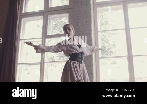 Ballet dance. Ballerina in a simple elegant elegant dress and ...