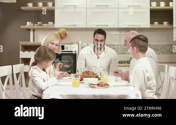 Family Sitting Around a Table, Eating, Communicating and Having Fun ...