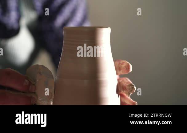 Traditional pottery making, man teacher shows the basics of pottery in ...