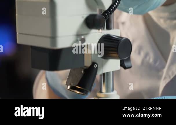 Laboratory worker examining abnormal structure of cells under ...