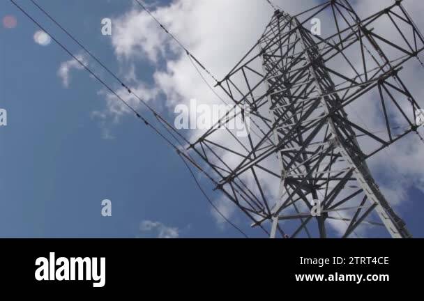 High voltage pylon with blue floating sky background Stock Video ...