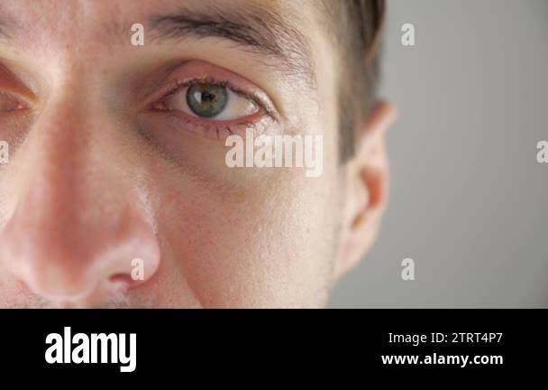 Half face portrait of sad man crying with tears in eye. Man in despair ...