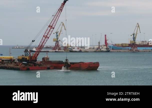 Dredge ship is grabbing sand from the button of harbor at Iraklion and ...