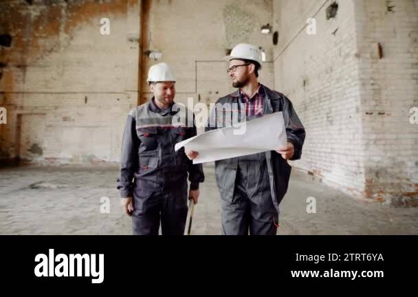 Worker and foreman at the construction site of the workshop. The ...