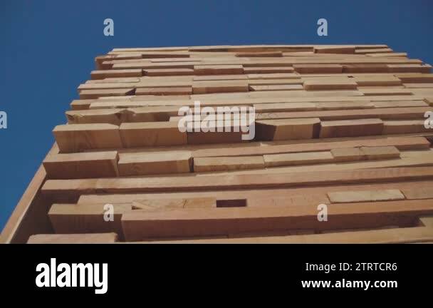 Wooden beams and boards neatly stacked in a pyramid shape Stock Video ...