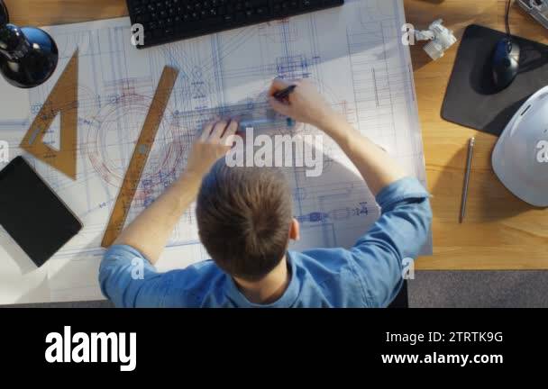 Top View of a Technical Engineer Working on His Blueprints, Drawing on ...