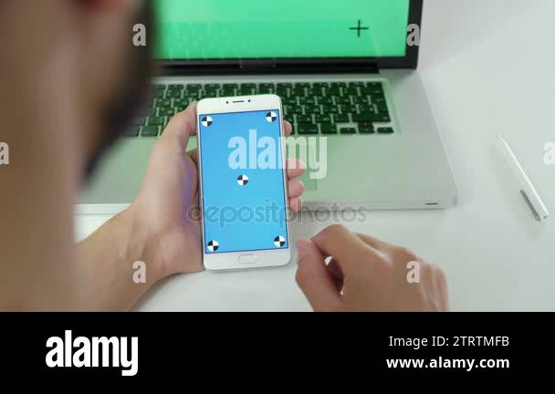 Close up man hands holding smart phone with green screen. Chroma Key. Close up male hands ...