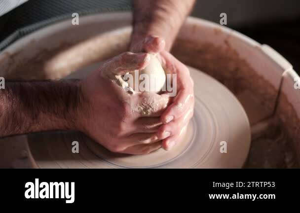 Artist operates hands, which gently creating correctly shaped handmade ...