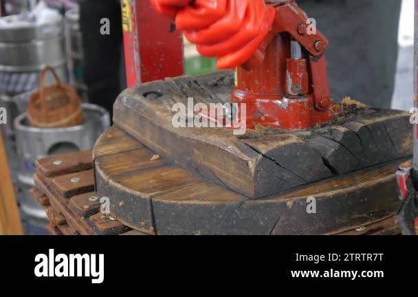 Traditional wine press. Old technique of winemaking. Fresh white grape ...