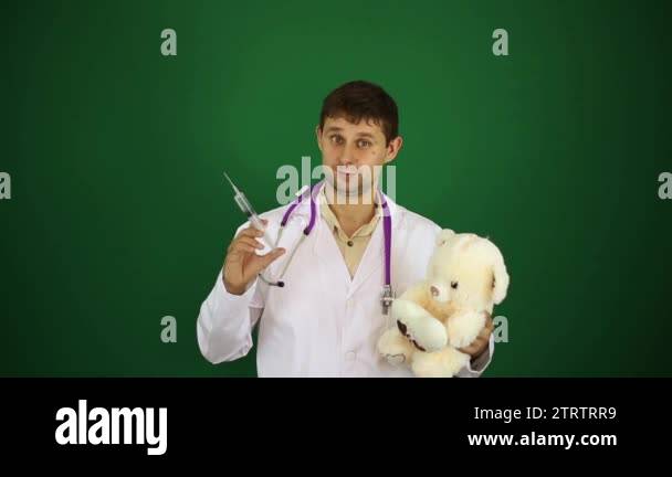 Doctor makes an injection of a teddy bear. A children's doctor and a ...