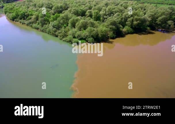 Two rivers of different colors of water merge into one large river ...
