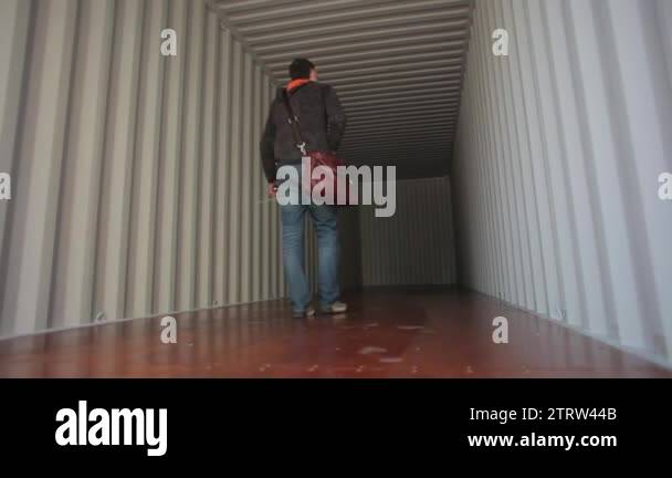 Inside an empty shipping container. Man is checking a container Stock ...