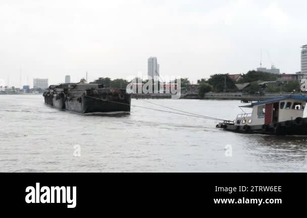 The tug boats towing a big barge with sand. Cargo ship in a river Stock ...