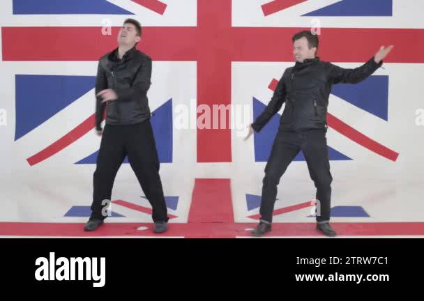 Two good-looking men in black leather motorcycle jackets energetically ...