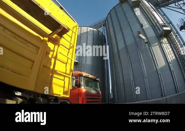 Semi-Trailer Truck Delivers Grain To Grain Elevator. Grain Storage Bins ...