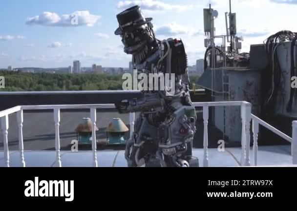Robot moves his hands on background of city skyline and blue sky ...