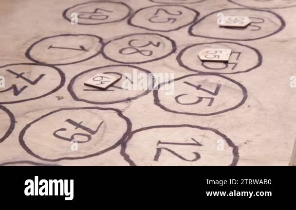 young teenage girls playing on board game with numbers and firewood in ...