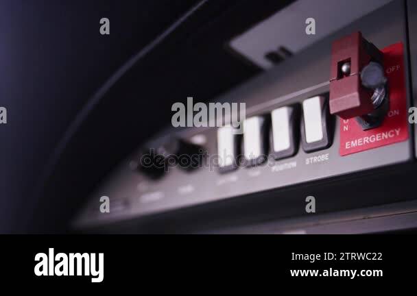 Plane control panel. Switches on plane cockpit. Red emergency button in ...