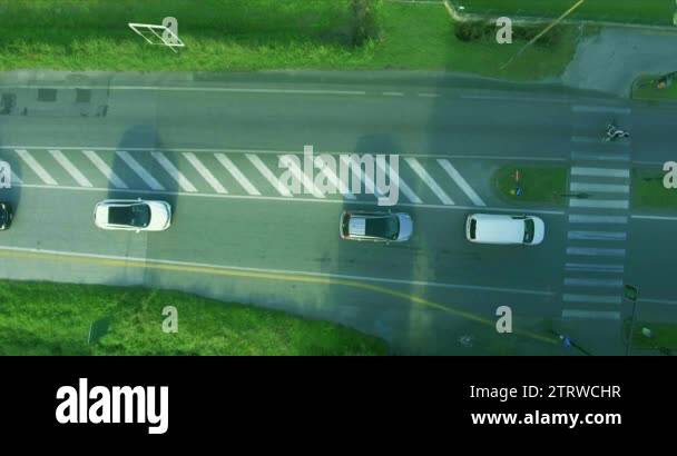 Cars on the road stopped for a red light, skipping the bicyclist. A ...