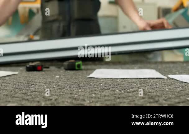 Production and manufacturing of pvc windows, male worker is making ...