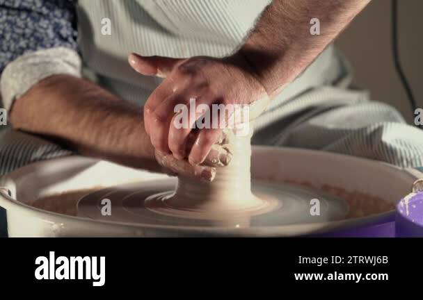 Artist operates hands, which gently creating correctly shaped handmade ...