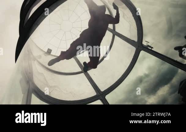 Woman flying in a wind tunnel. Indoor skydiving wind tunnel. Extreme ...