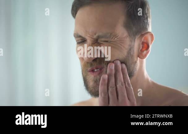 Sharp toothache disturbing man, dental caries, gingivitis, blurred ...